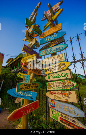 A wooden pole with an indicator of the direction and distance of a ...