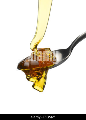 Golden Treacle flowing onto a spoon Stock Photo - Alamy