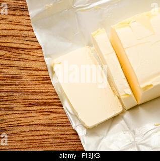 Butter Margarine block in a wooden tray with herbs. White wooden ...
