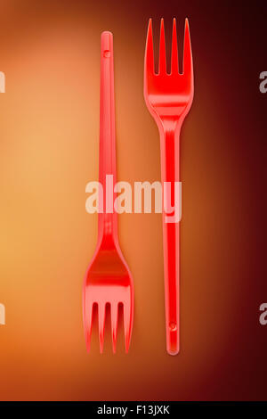 Red plastic forks vertical in close up Stock Photo - Alamy