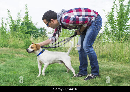 Man trains dog Stock Photo - Alamy