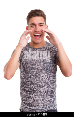 Angry young man screaming isolated over blue background Stock Photo - Alamy