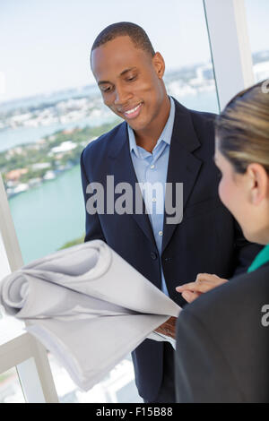 Young male engineer with blueprint on blue background Stock Photo - Alamy