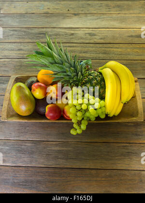 Fresh grapes in wooden bowl on wooden table Stock Photo - Alamy