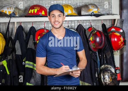 Confident Firefighter Holding Clipboard At Fire Station Stock Photo ...