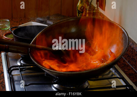 Flambé in a wok Stock Photo - Alamy