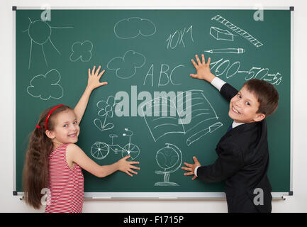 Schoolgirl girl studies globe at school on geography Stock Photo - Alamy