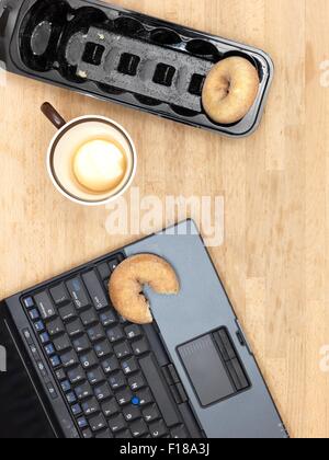 A conceptual lifestyle image of doughnuts on a work desk Stock Photo ...