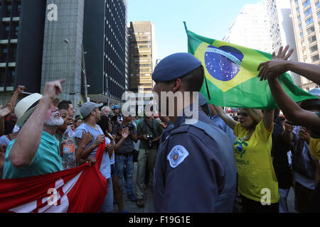 A police officer stands between people arguing next to an anti-Iranian ...