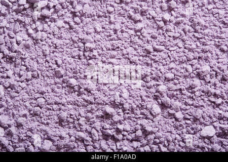 Texture of broken violet eye shadow isolated on white background. Macro ...