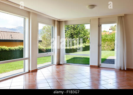 room with terracotta floor, windows overlooking the garden Stock Photo ...
