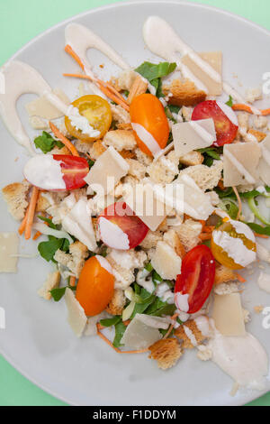 Plate with Caesar salad on color background, closeup Stock Photo - Alamy