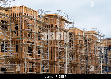 Wood frame construction of new apartment building with windows cutout ...