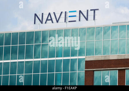 A logo sign outside of the headquarters of the Navient Corporation in ...