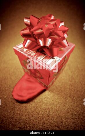 Red gift box with bow on wooden board holidays concept Stock Photo - Alamy