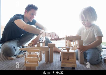 Boy carrying basket of wooden blocks Stock Photo - Alamy