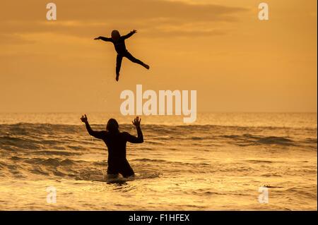 Father and son looking at sunset Stock Photo - Alamy