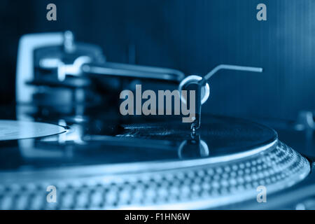 Dj needle on record, blue tones Stock Photo - Alamy