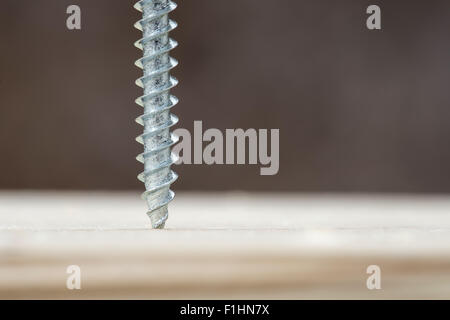 Closeup of screw being screwed into a wooden plank - macro shoot ...