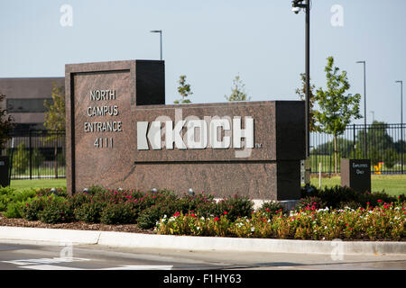 A logo sign outside of the headquarters of Koch Industries, Inc., in ...