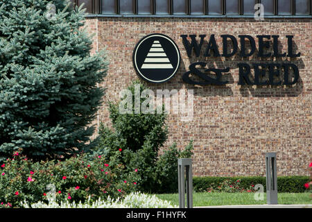 A logo sign outside of the headquarters of Waddell & Reed Financial ...