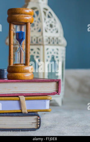 Books, hourglass and magnifier on wooden Stock Photo - Alamy