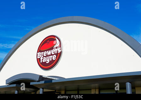 Logo sign for Brewers Fayre restaurant, above a food retail outlet ...