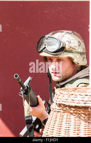 American army, black Hawk re-enactment. Weary looking soldier taking ...