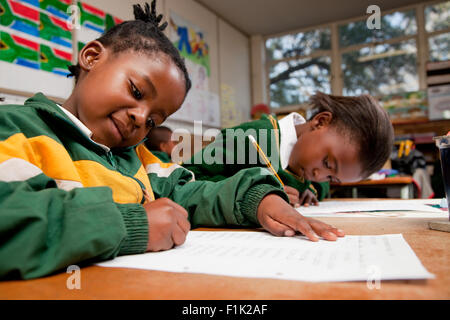 Two young primary 6 year old school children at home in school uniforms ...