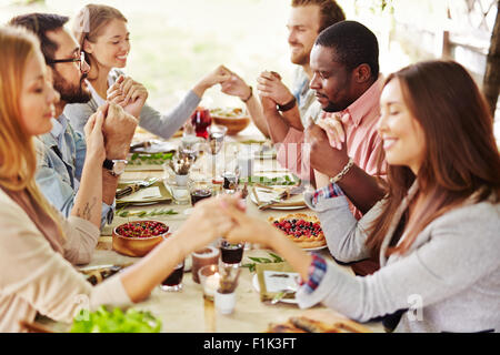 Young man praying at table in kitchen Stock Photo - Alamy