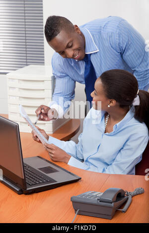 Managers helping employee business Stock Photo - Alamy