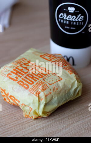 McDonald's Cheeseburger in a wrapper Stock Photo - Alamy