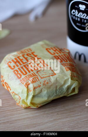 McDonald's Cheeseburger in a wrapper Stock Photo - Alamy