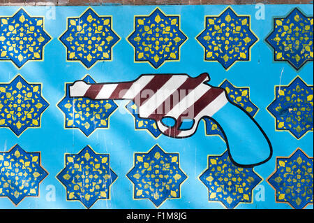 Graffiti on a wall, symbol, American revolver and Iranian pattern ...