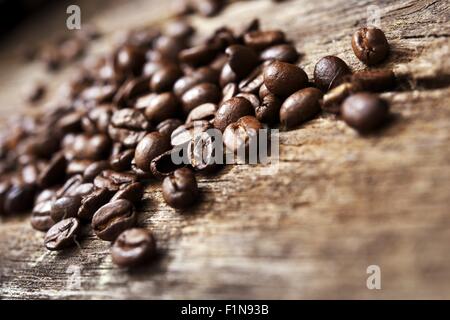 Closeup of some coffee beans on a table Stock Photo - Alamy