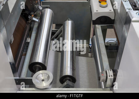 Large printing press with paper roll printing newspaper on production ...