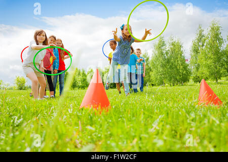 Boy throwing a plastic hoop on a pole Stock Photo - Alamy