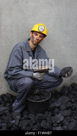 Miner hammer smashing a stone coal Stock Photo - Alamy