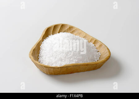 Coarse grained salt in triangle wooden bowl Stock Photo - Alamy