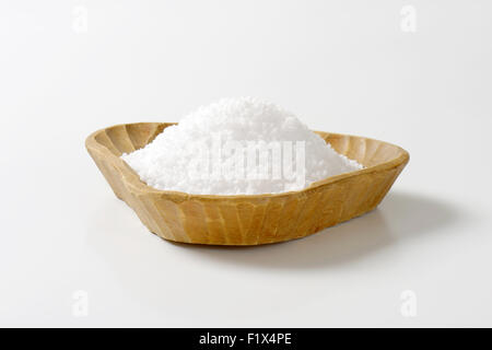 Coarse grained salt in triangle wooden bowl Stock Photo - Alamy