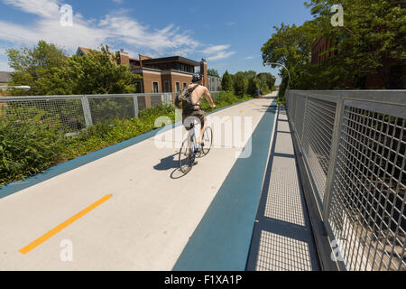 Bicyclists on the 606 elevated bike trail, green space and park built ...