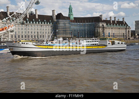 The general cargo ship, Polla Rose steams upriver on the River Thames ...