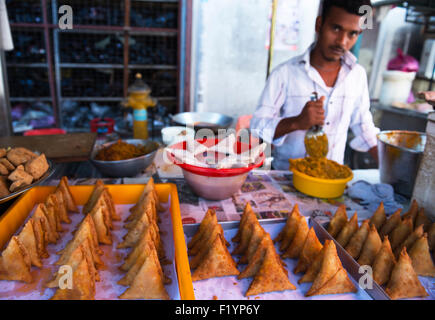A Tamil man making Samosas in a small stall in the streets of ...