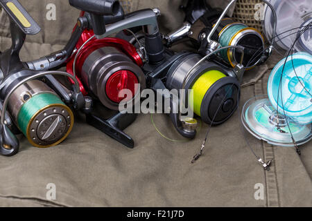 fishing reels with line different colors on cloth background Stock ...