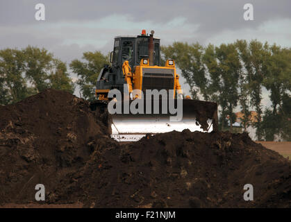 Bulldozer in operation moving dirt and clearing the land Stock Photo ...
