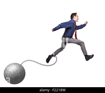 Man with metal ball and chain on his leg against grey background ...