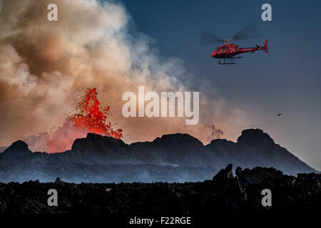 Helicopter flying over the volcano eruption at the Holuhruan Fissure ...