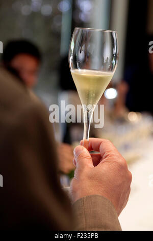 Holding a glass of cava Stock Photo - Alamy