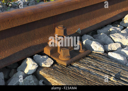 Rusty bolts and screws on a railroad track Stock Photo - Alamy