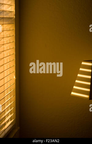 the sun is shining through the blinds Stock Photo - Alamy